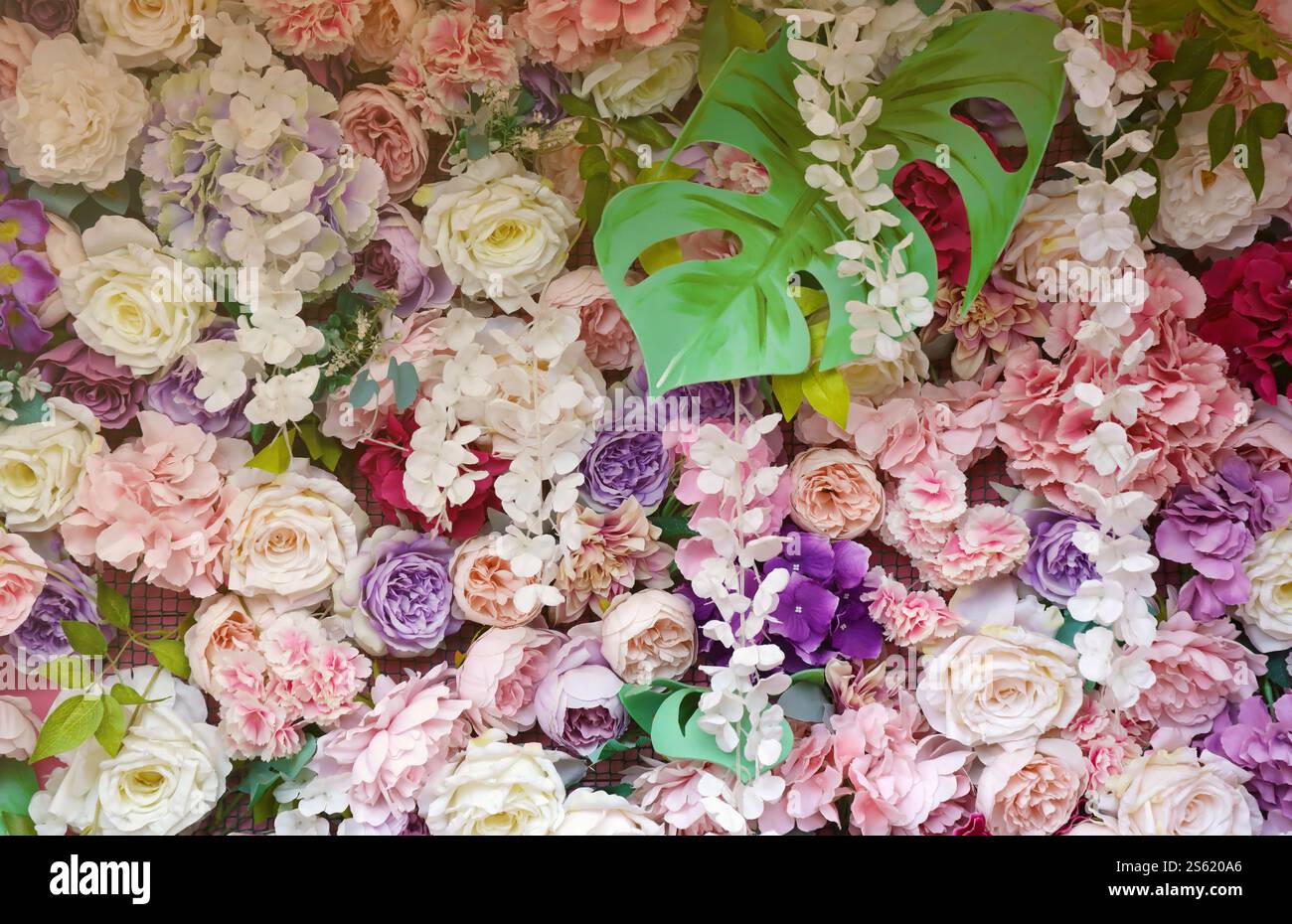 Floral background. Lot of artificial flowers in colorful composition on ...