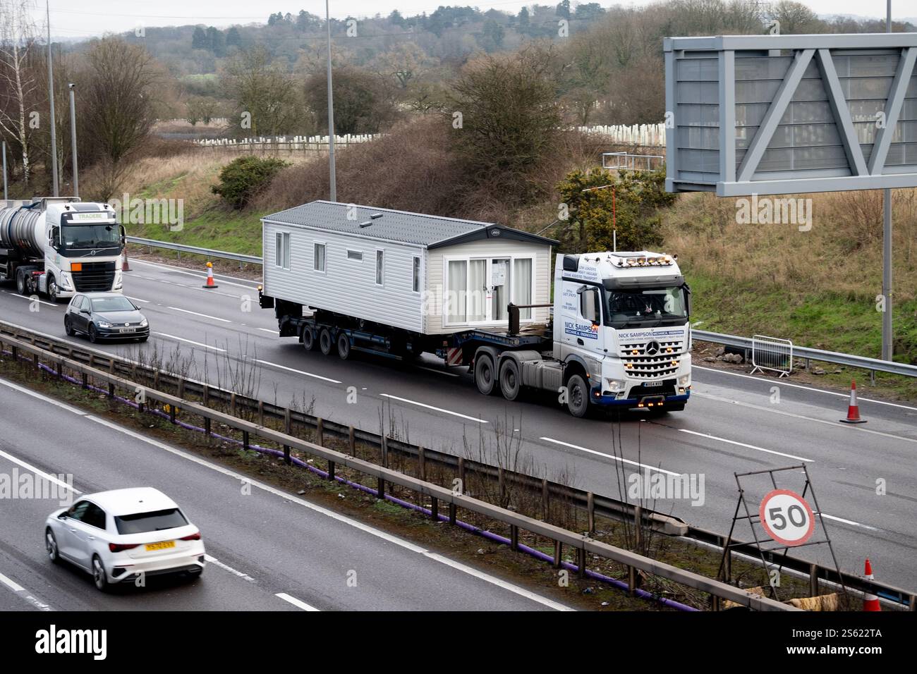Nick Samson low-loader lorry carrying a small building on the M42 ...