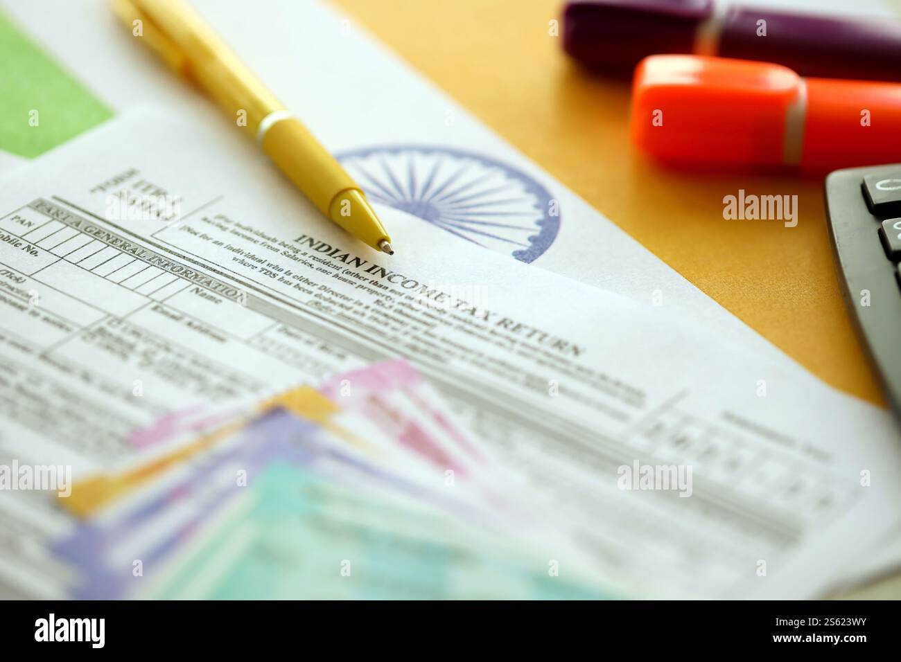 Indian income tax return blank form with pen and indian rupees bills on ...