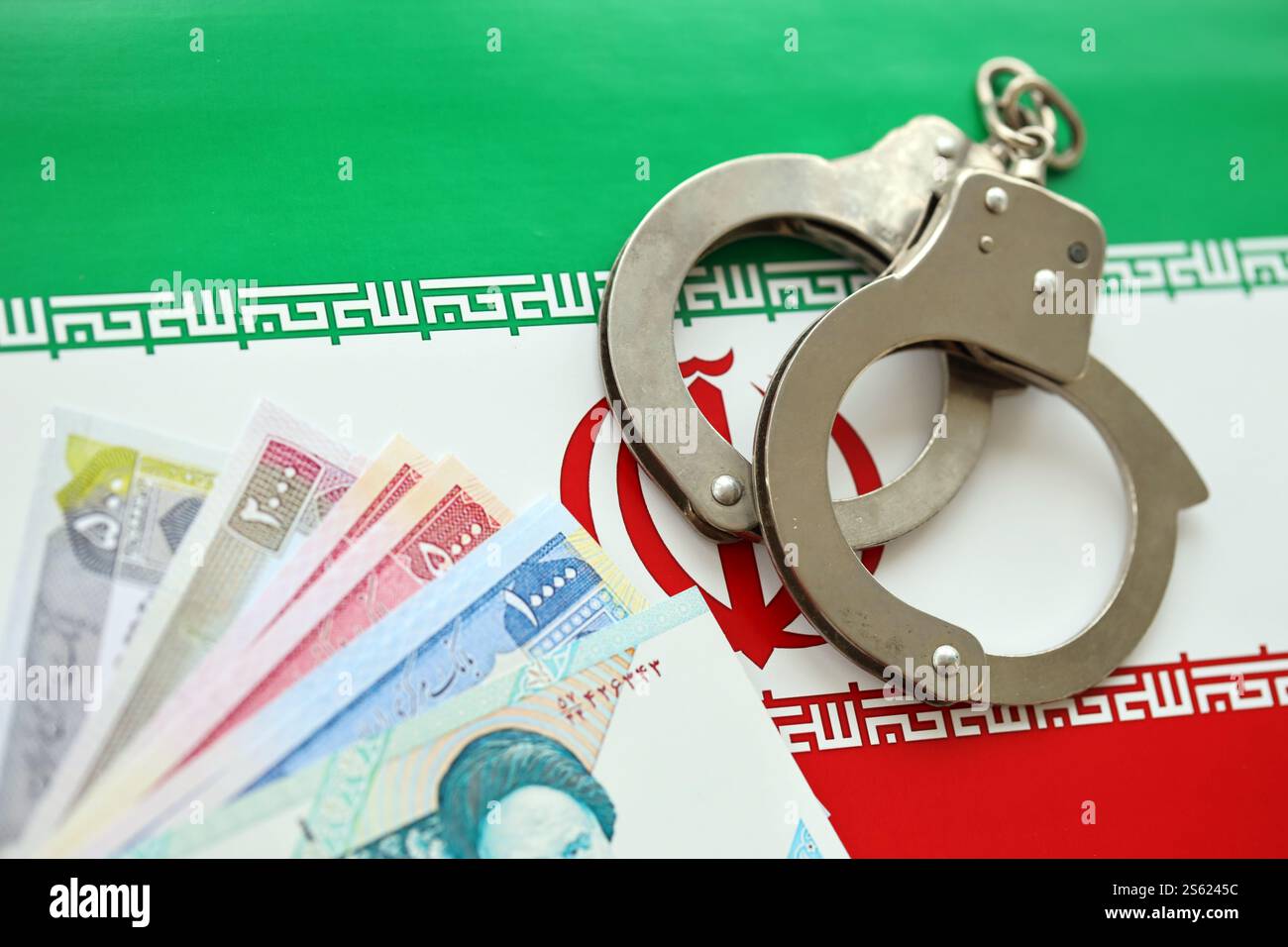 Iran flag and police handcuffs with iranian money bills rials. The ...