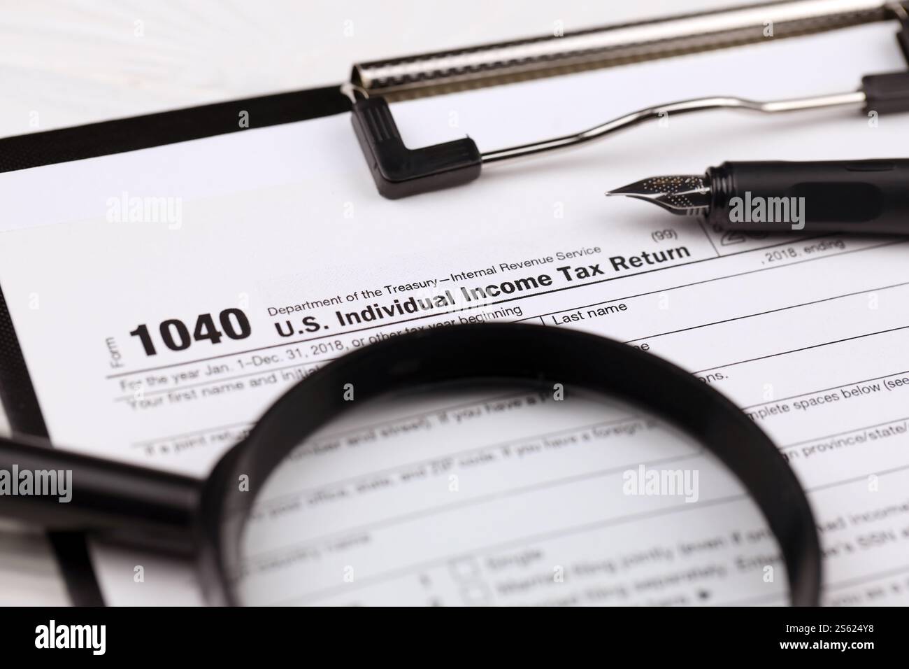 Form 1040 US Individual Income Tax Return on A4 tablet lies on office table with pen and ...