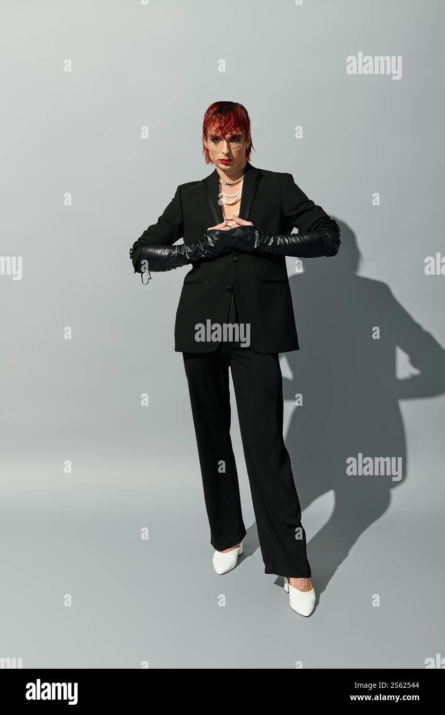 A stylish young man stands confidently in a sleek suit, highlighting ...