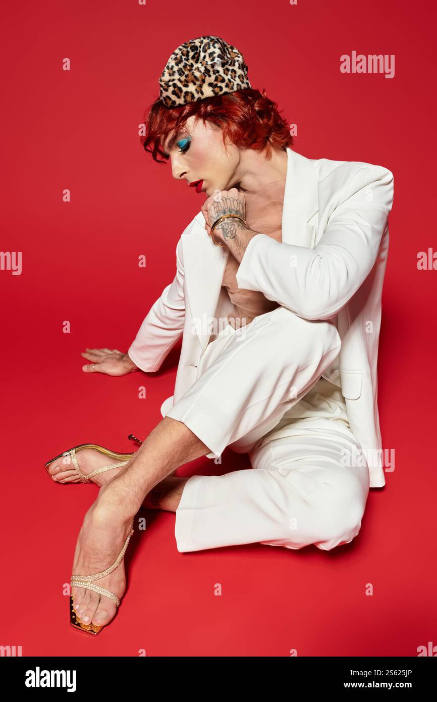 A striking figure in a white suit poses confidently with stylish ...