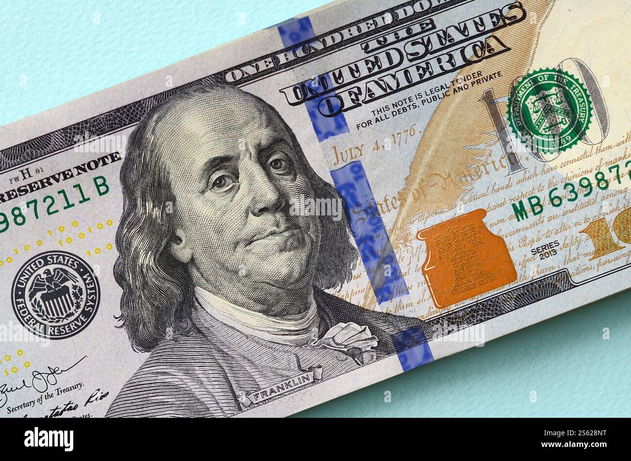 US dollar bills of a new design with a blue stripe in the middle is ...