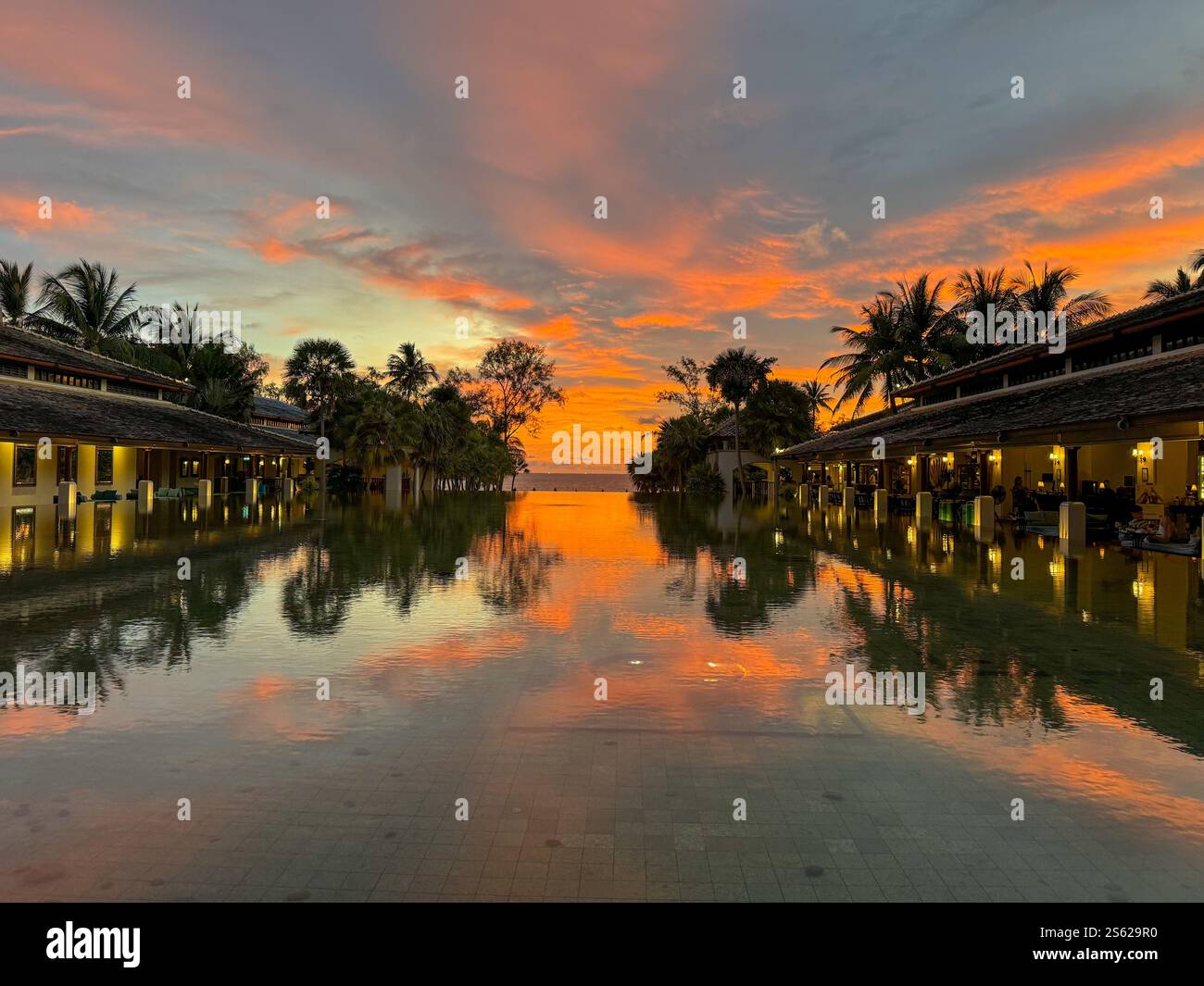 Dramatic sunset over water feature in Phuket, Thailand. Dramatic colors ...