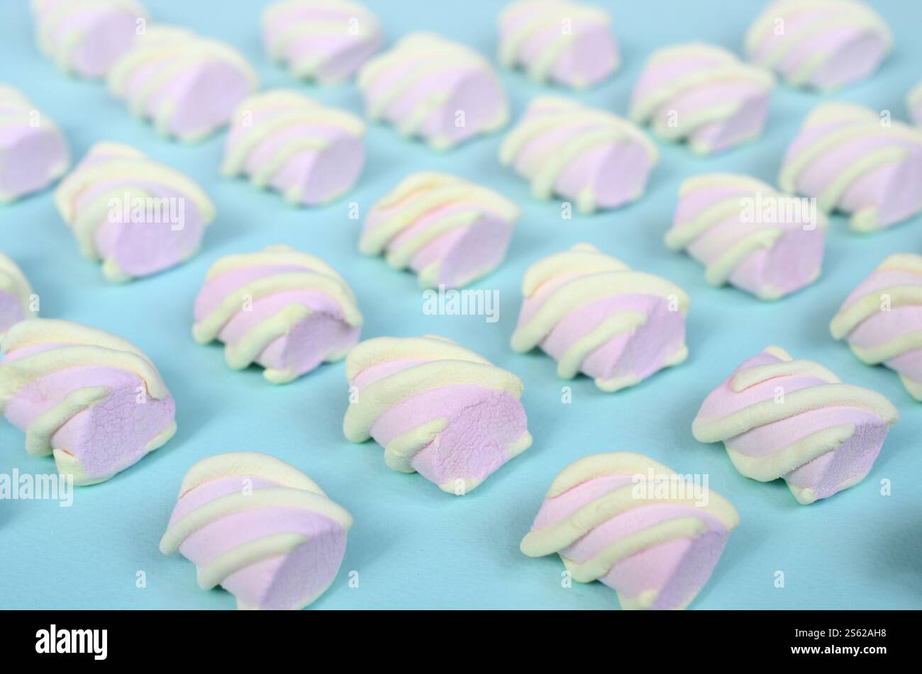 Colorful marshmallow laid out on blue paper background. pastel creative ...