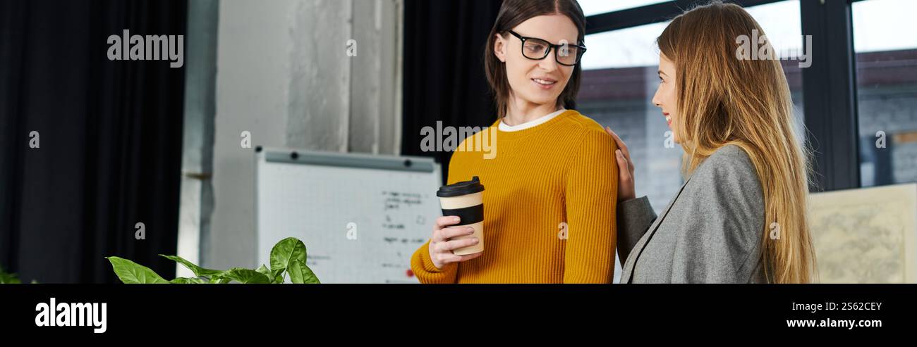 Two young people engage in cheerful conversation while sipping coffee ...