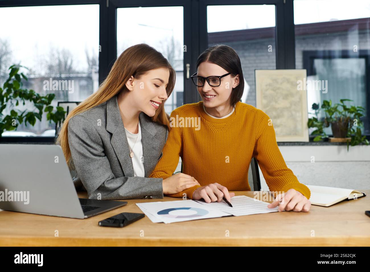 Two young people engage in a lively discussion about their project ...