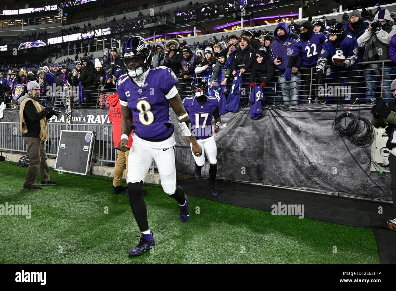 Baltimore Ravens quarterback Lamar Jackson takes the field to work out ...