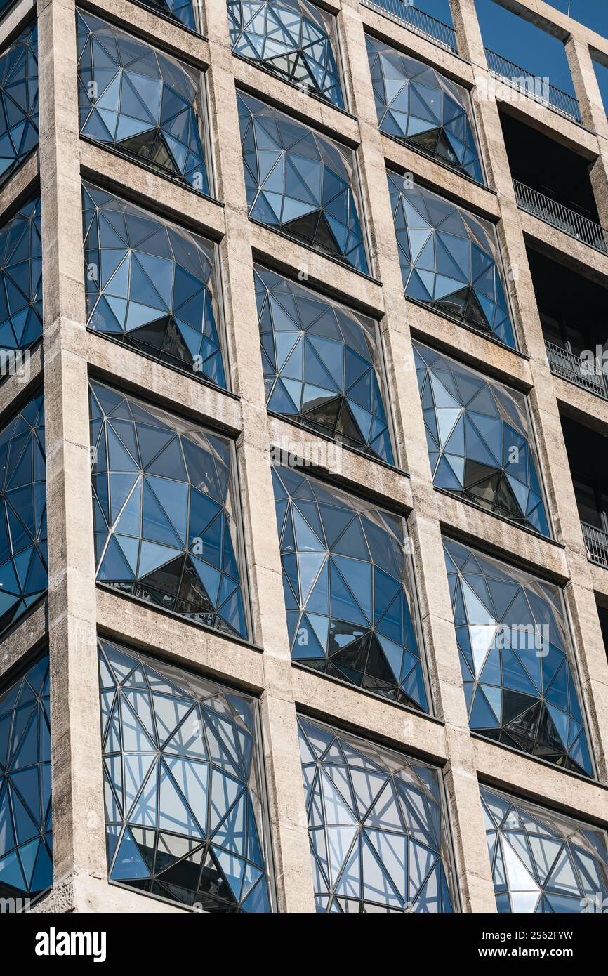 Close-up modern building facade, industrial aesthetic, featuring large ...