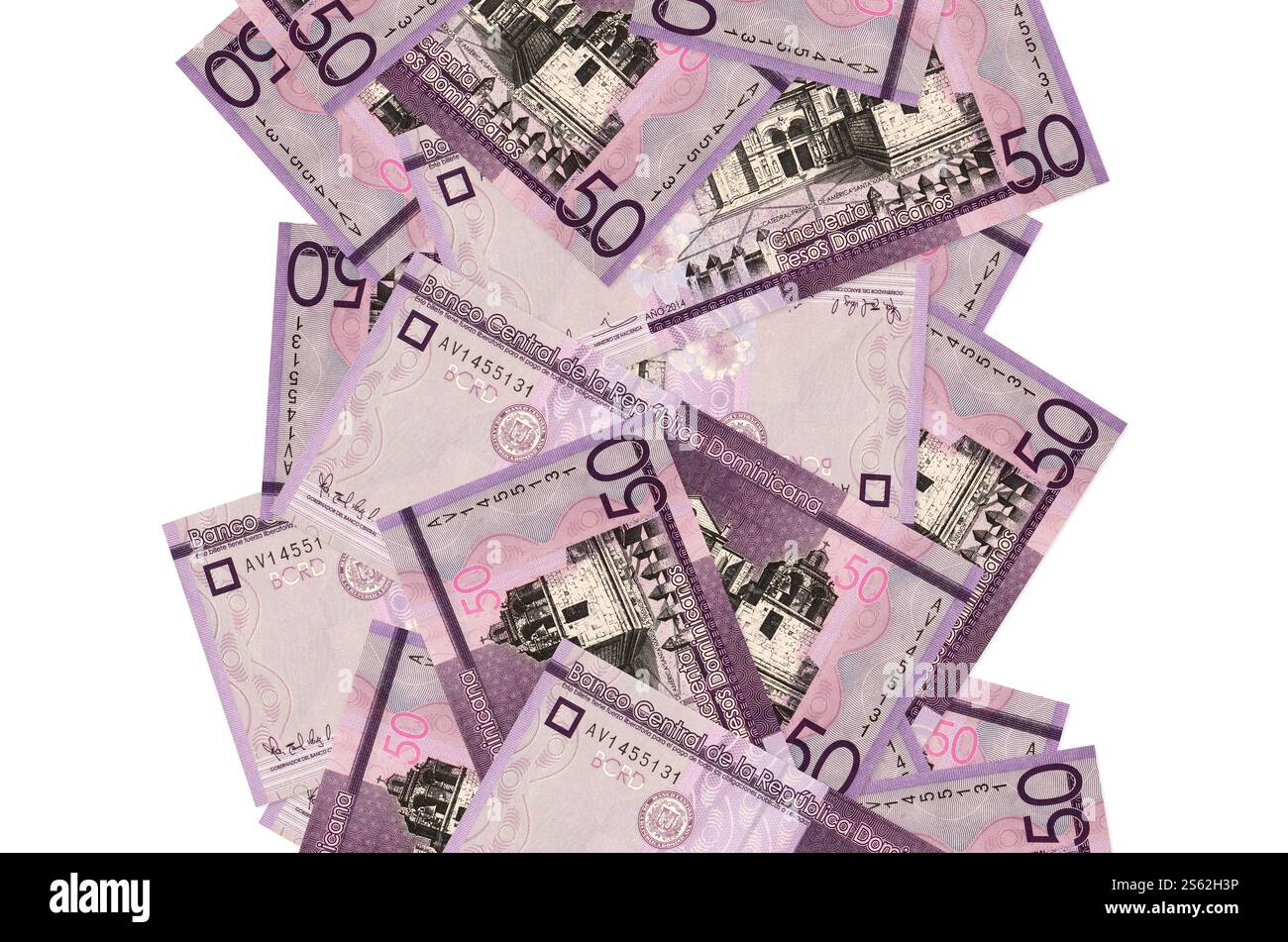 50 Dominican pesos bills flying down isolated on white. Many banknotes ...