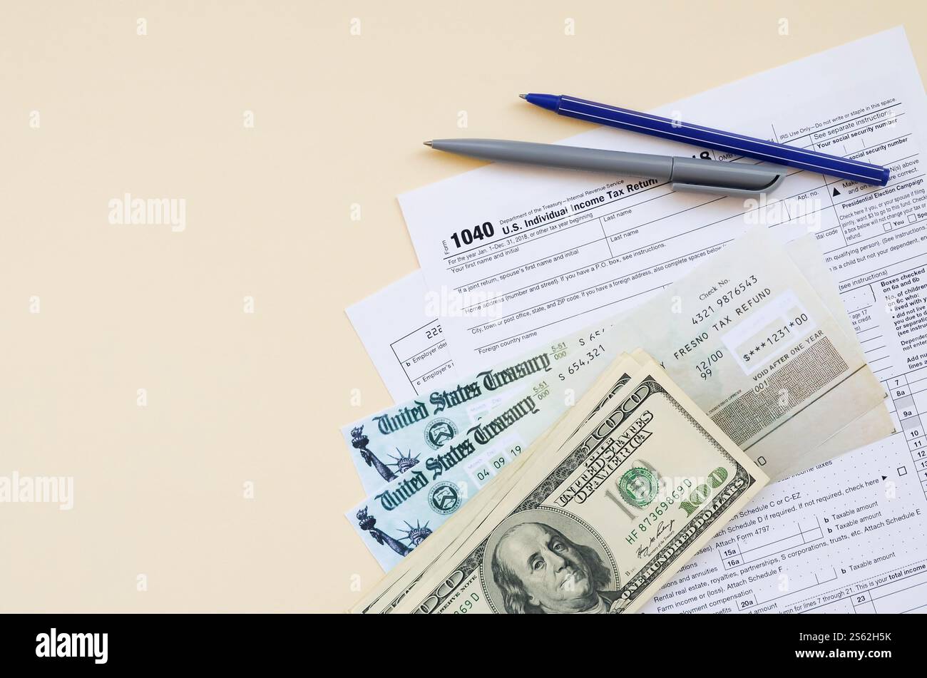 1040 Individual Income tax return form with Refund Check and hundred ...