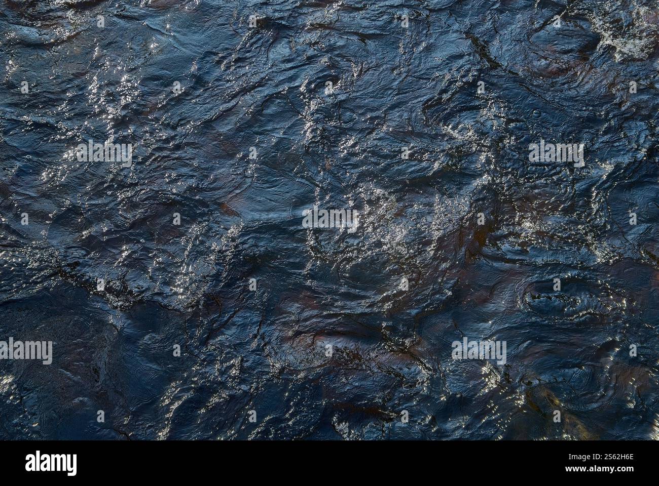 Swirling waters of shallow flowing river stream Stock Photo - Alamy