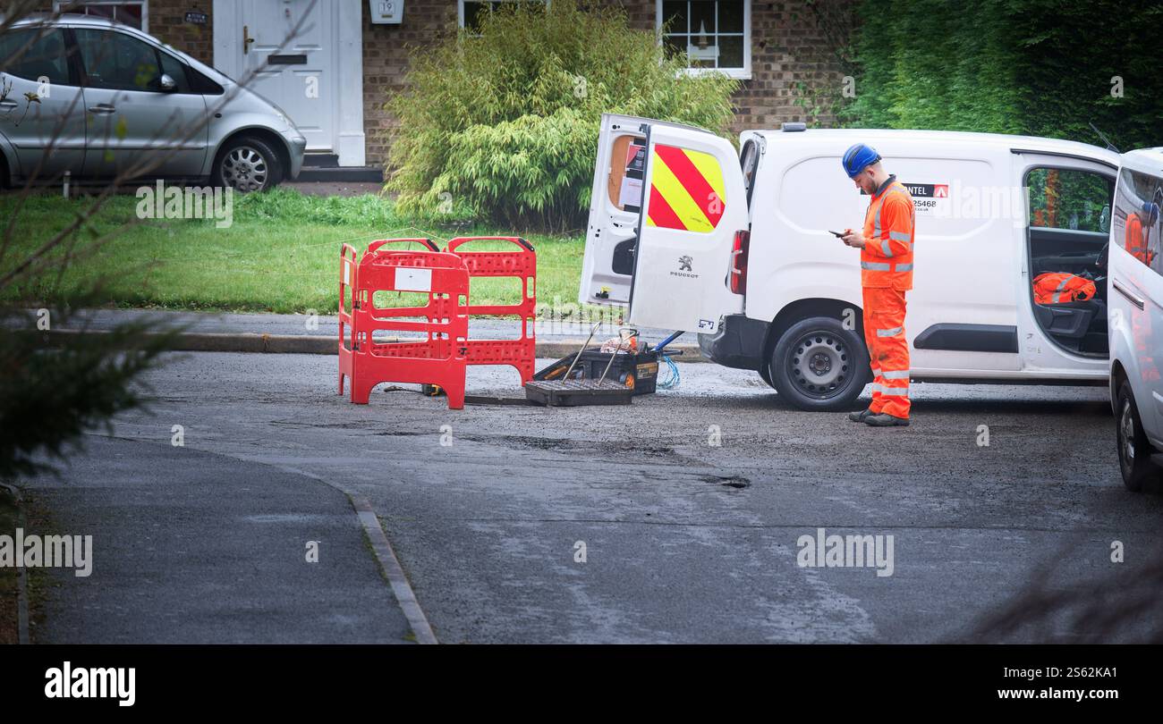 Workman, with van, from Enviromontel, clears a drain on a street in ...