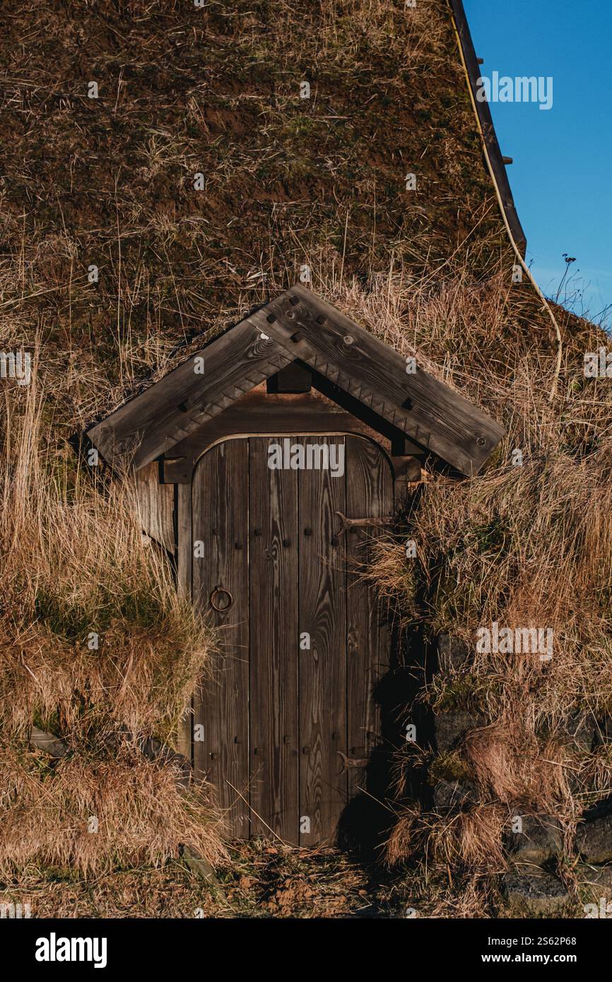 Close-up of a carved wooden door on a traditional turf house in ...