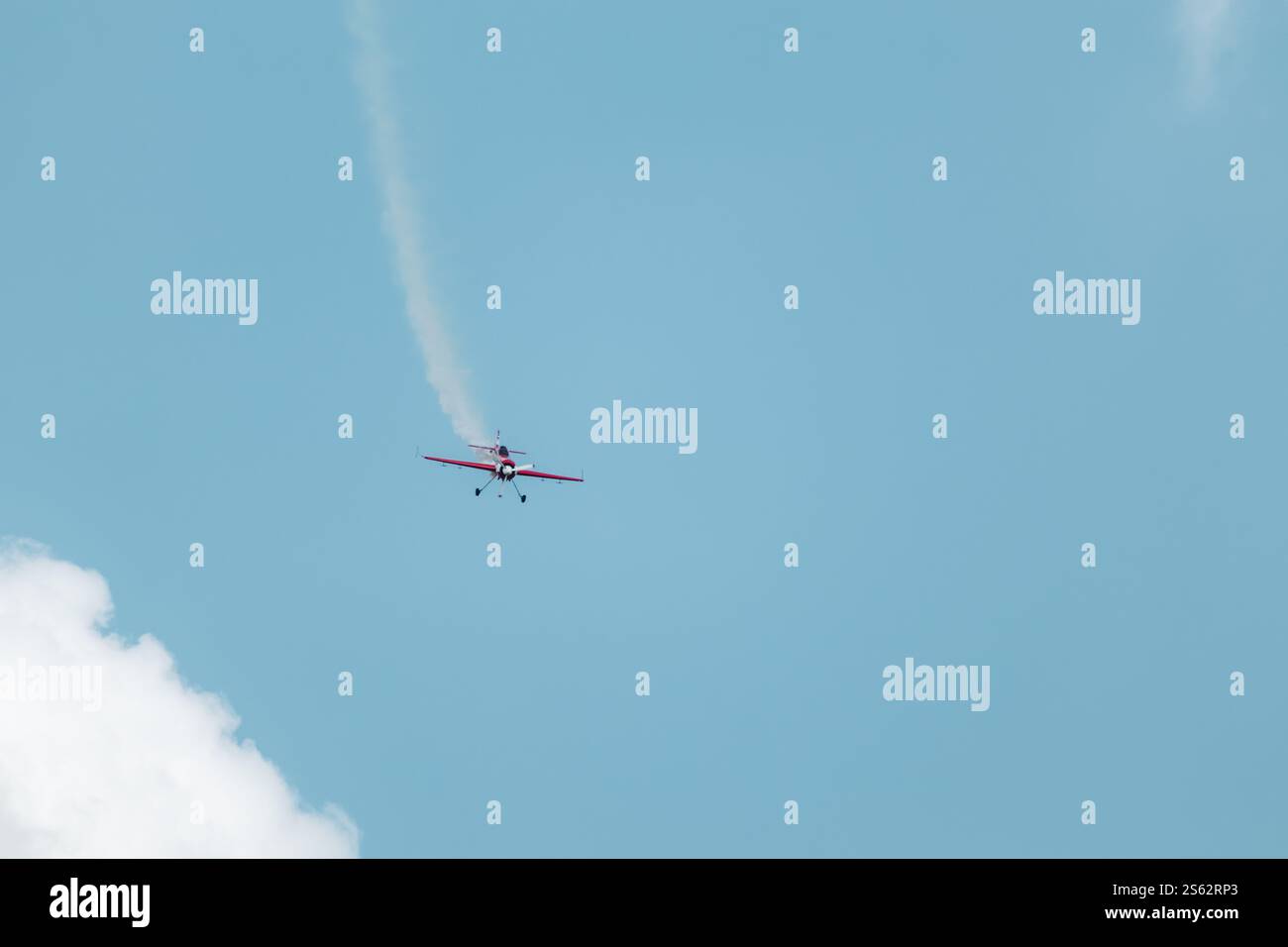 Su-31 Aircraft plane performing stunts in blue sky above clouds Stock ...