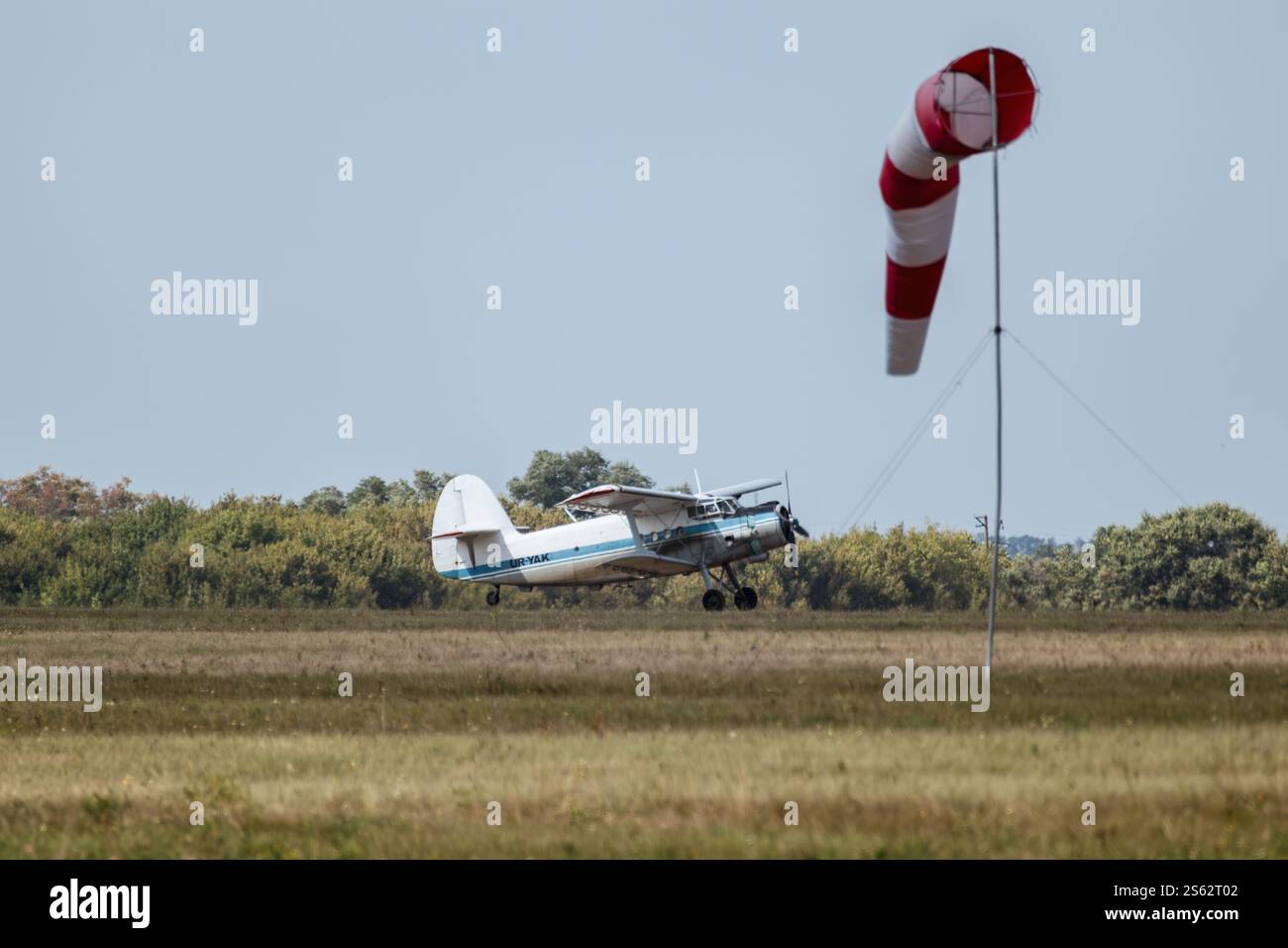 An-2 single-engine biplane passenger aircraft take-off on airshow field ...