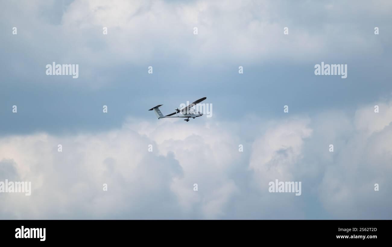 Aeroprakt A-40 Ukrainian tandem aircraft plane flying in cloudy sky on ...
