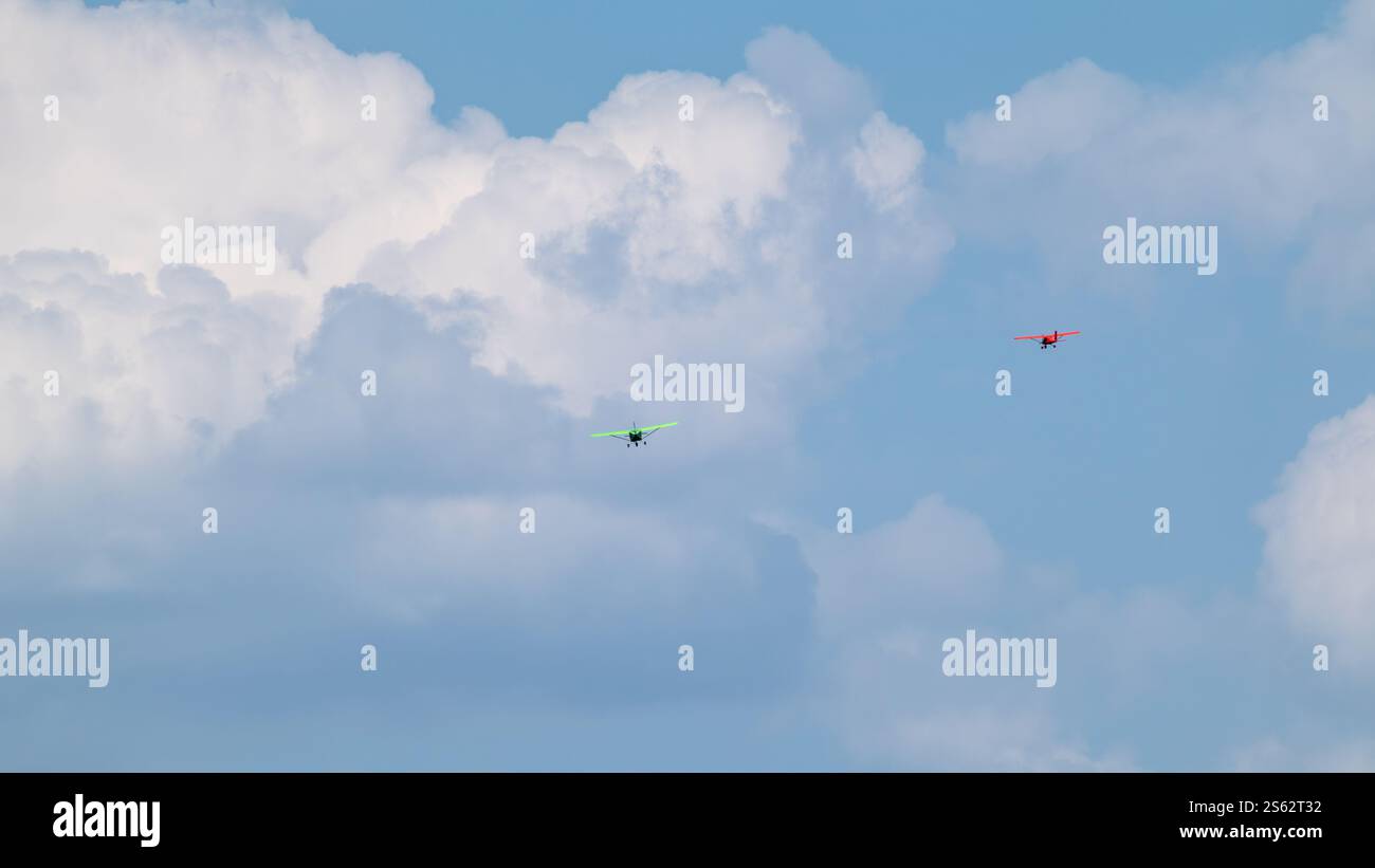 Green and Red Aeroprakt Ukrainian ultralight planes flying in cloudy ...