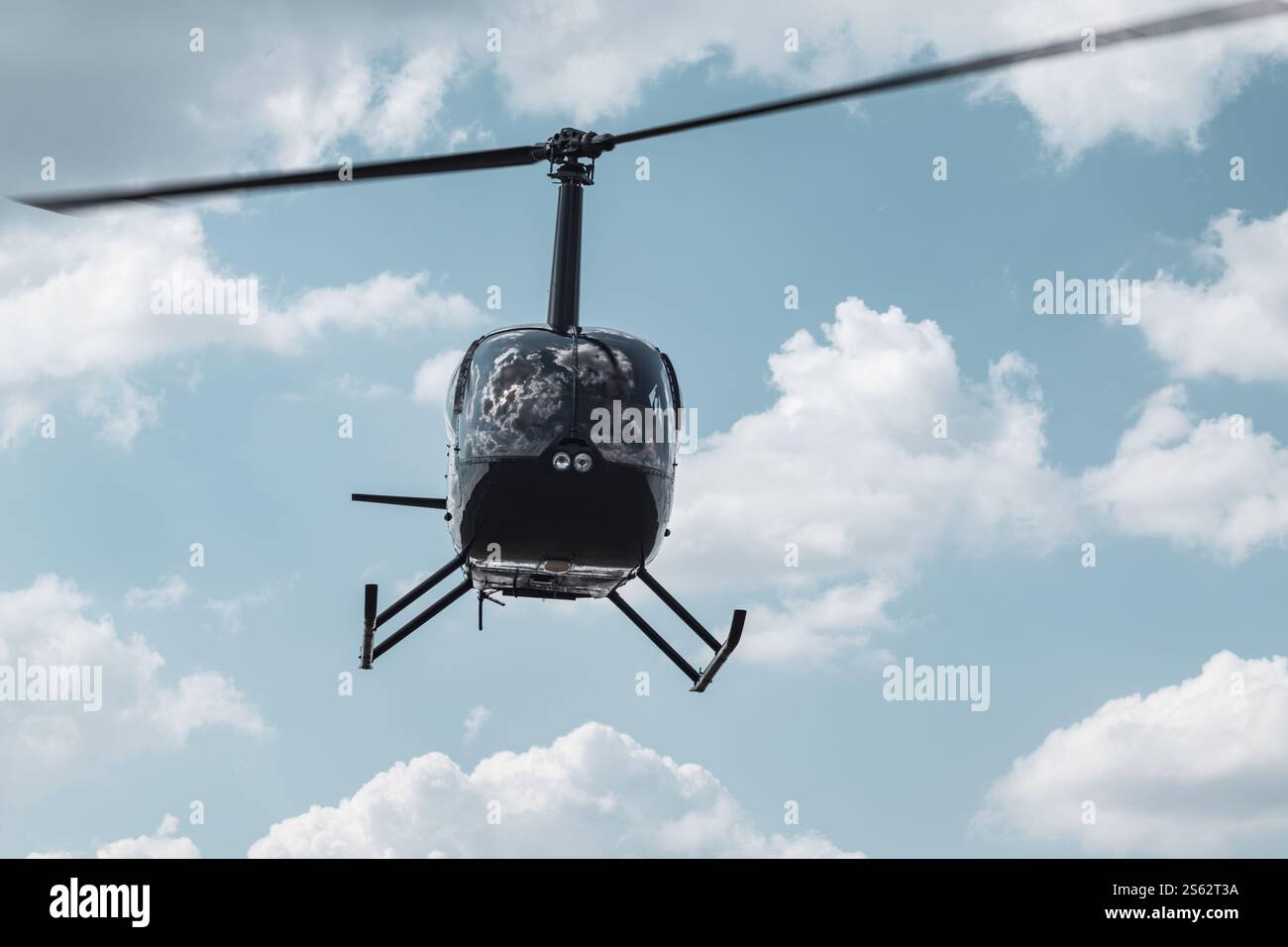 Shiny black helicopter cabin in cloudy sky background Stock Photo - Alamy