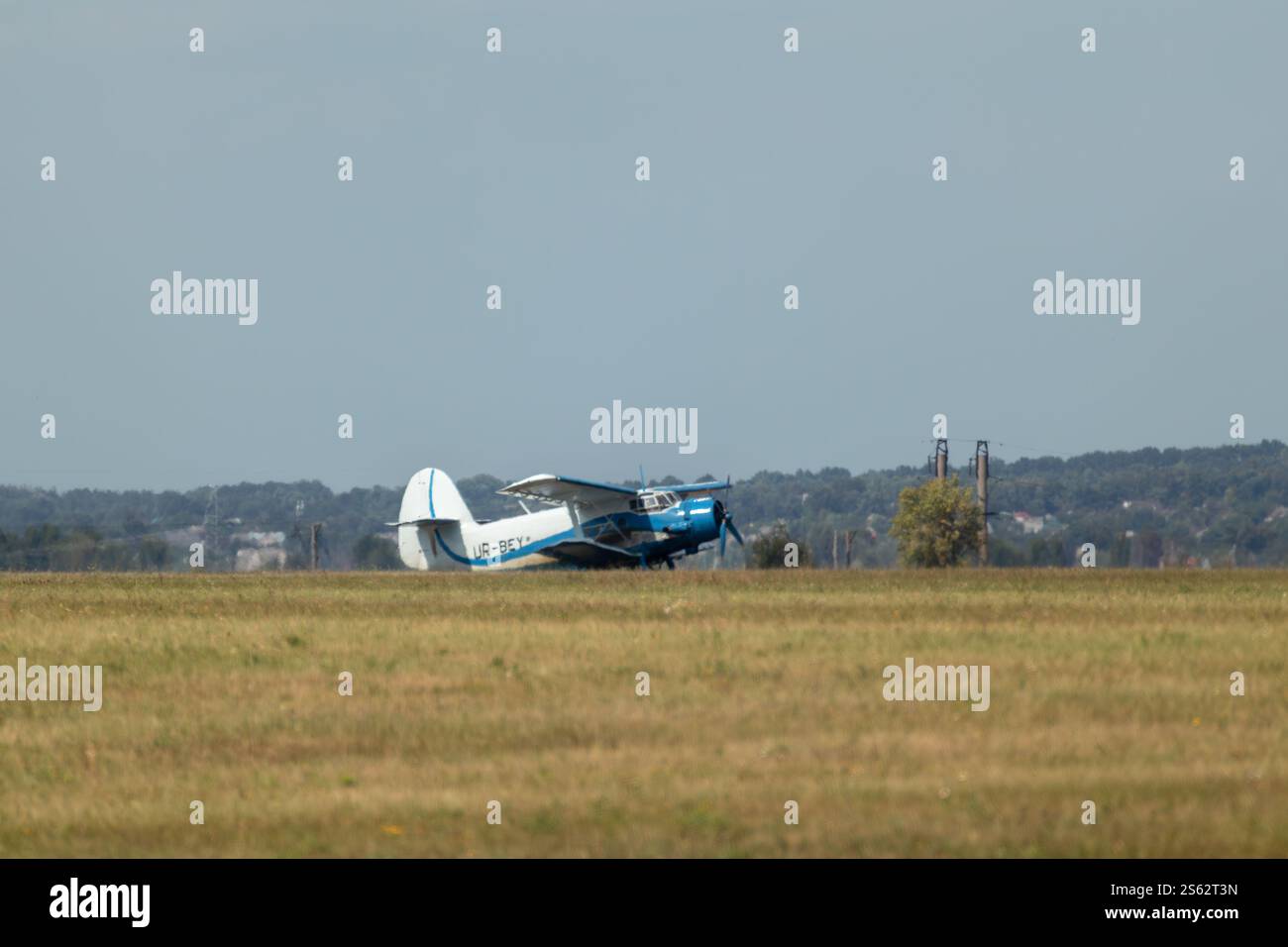 Light An-2 single-engine biplane aircraft take-off on airshow grass ...