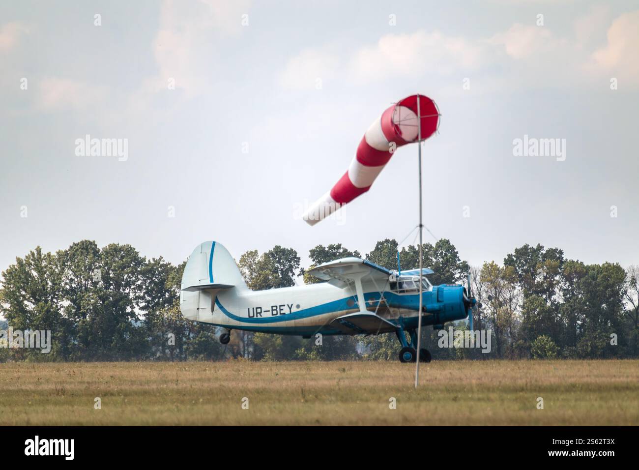 An-2 biplane passenger aircraft take-off on airshow grass landing field ...