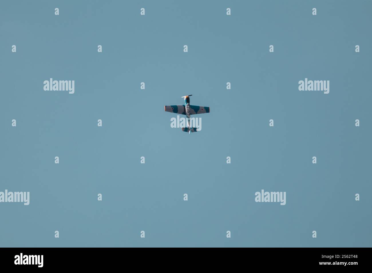 Yakovlev Yak-52 two-seat trainer aircraft plane flying in clear scenic ...