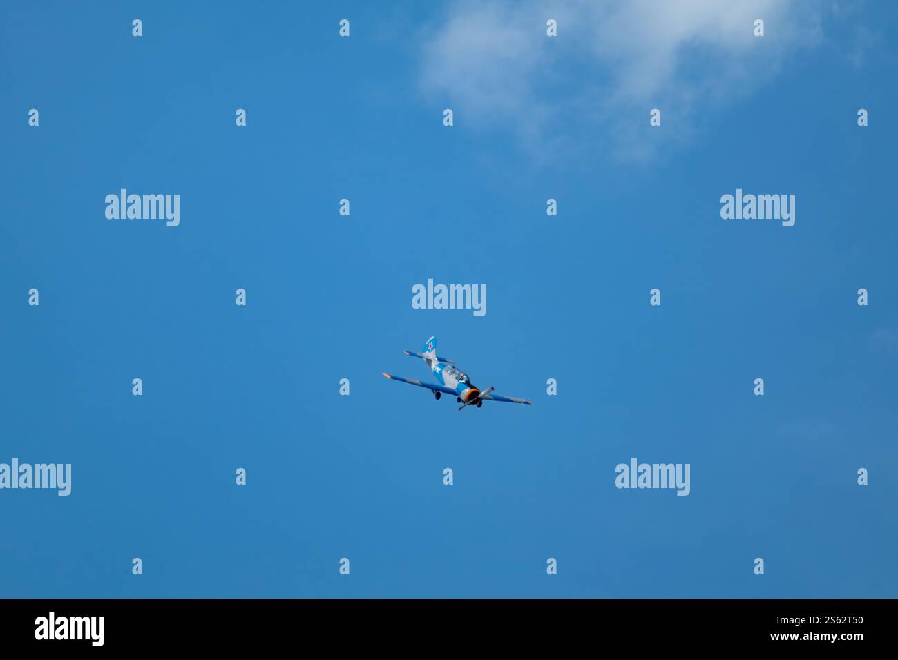 Shiny Yak-52 two-seat trainer aircraft plane flying in clear scenic sky ...