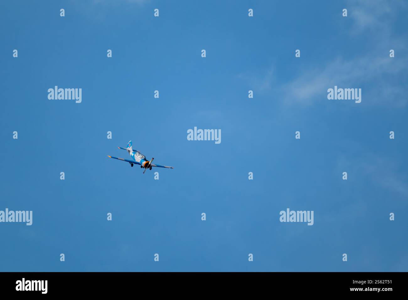 Aerobatics on Yak-52 two-seat trainer aircraft plane in clear blue sky ...