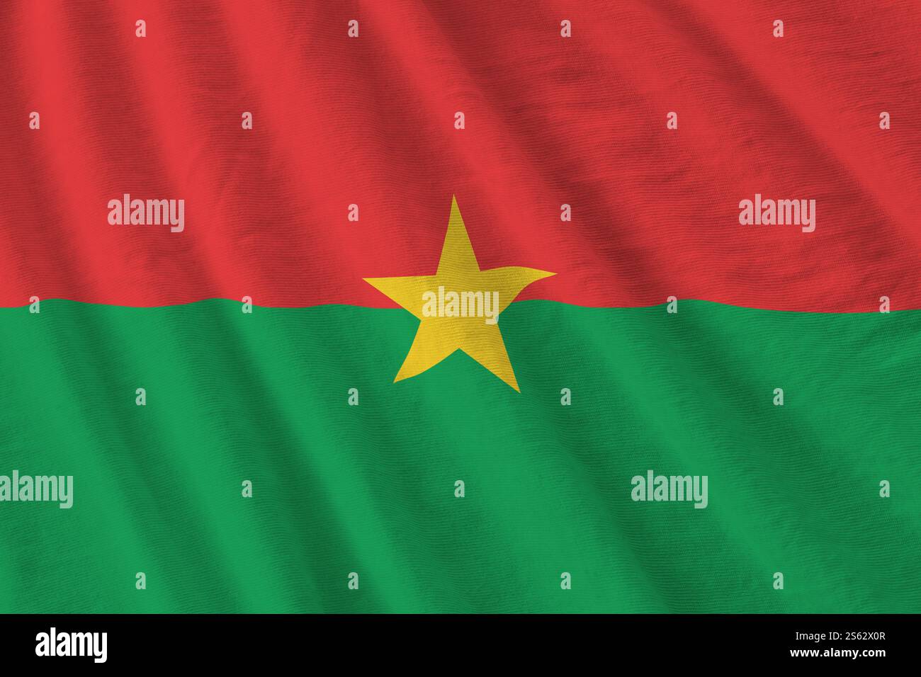 Burkina Faso flag with big folds waving close up under the studio light ...