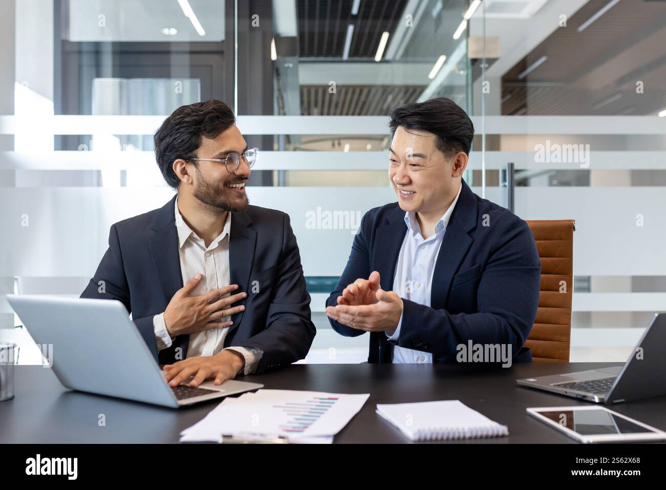 Two colleagues at workplace, Senior boss praising subordinate for ...