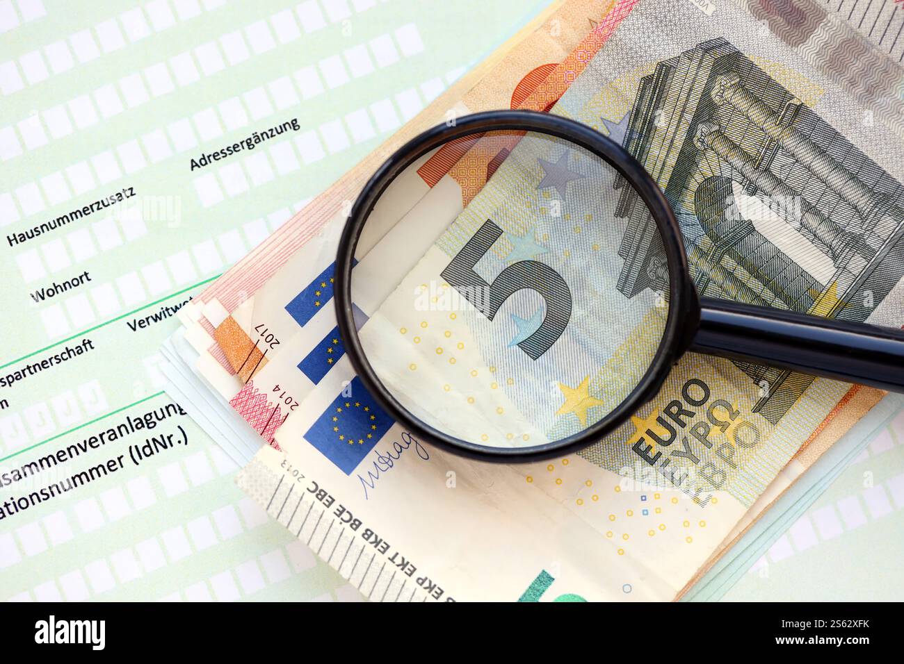 German income tax return form with magnifying glass and european euro ...