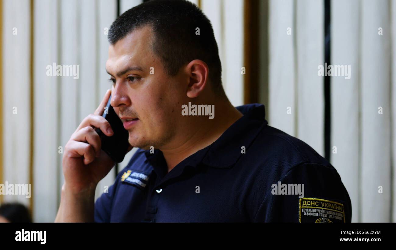 Male firefighter chief have serious telephone conversation with his ...