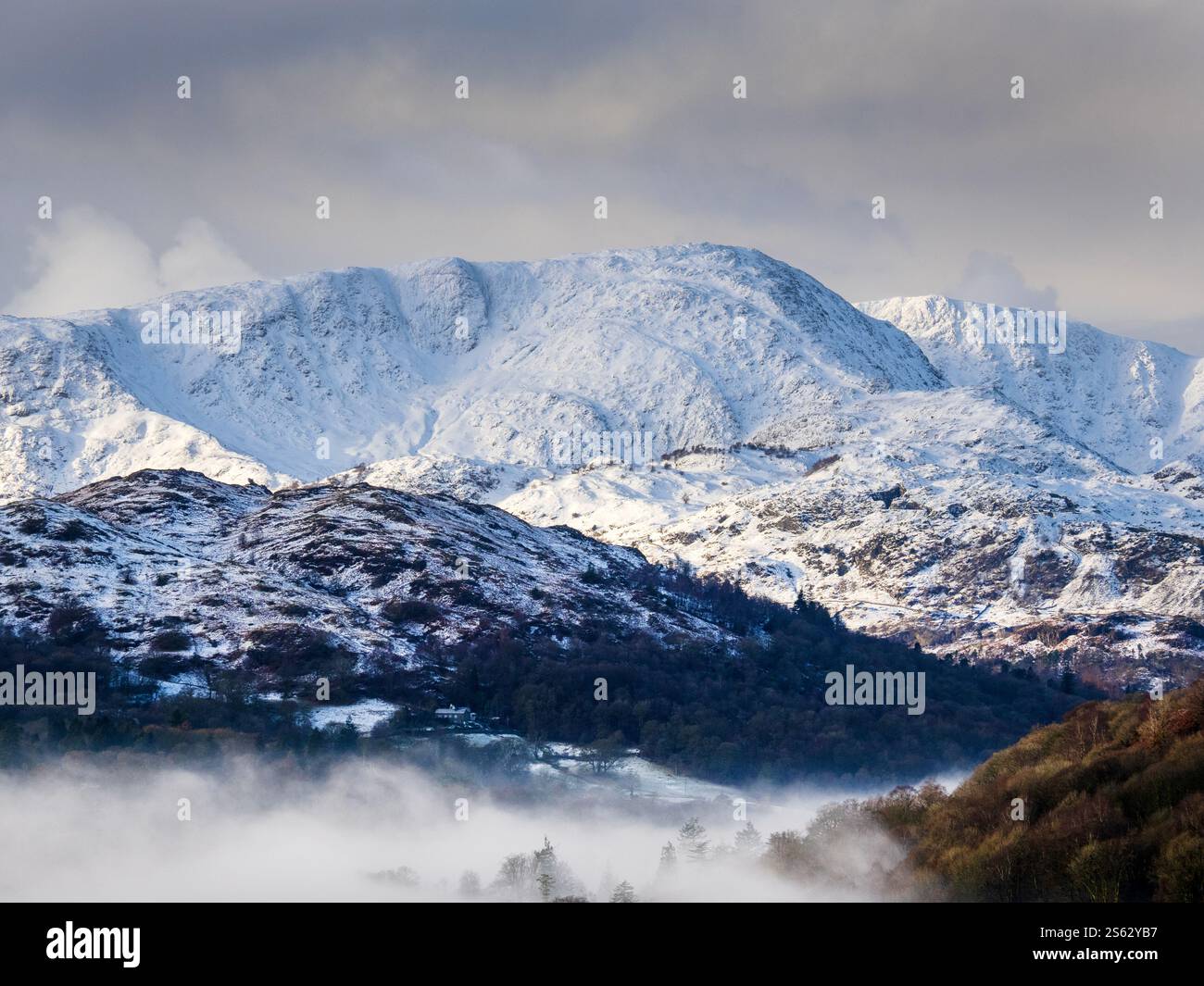 Snow on Wetherlam with valley mist from Ambleside, Lake District, UK ...