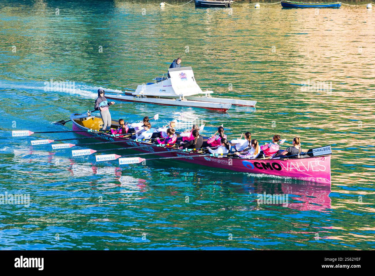 A Basque Trainera with coordinated rowers glides during a training ...