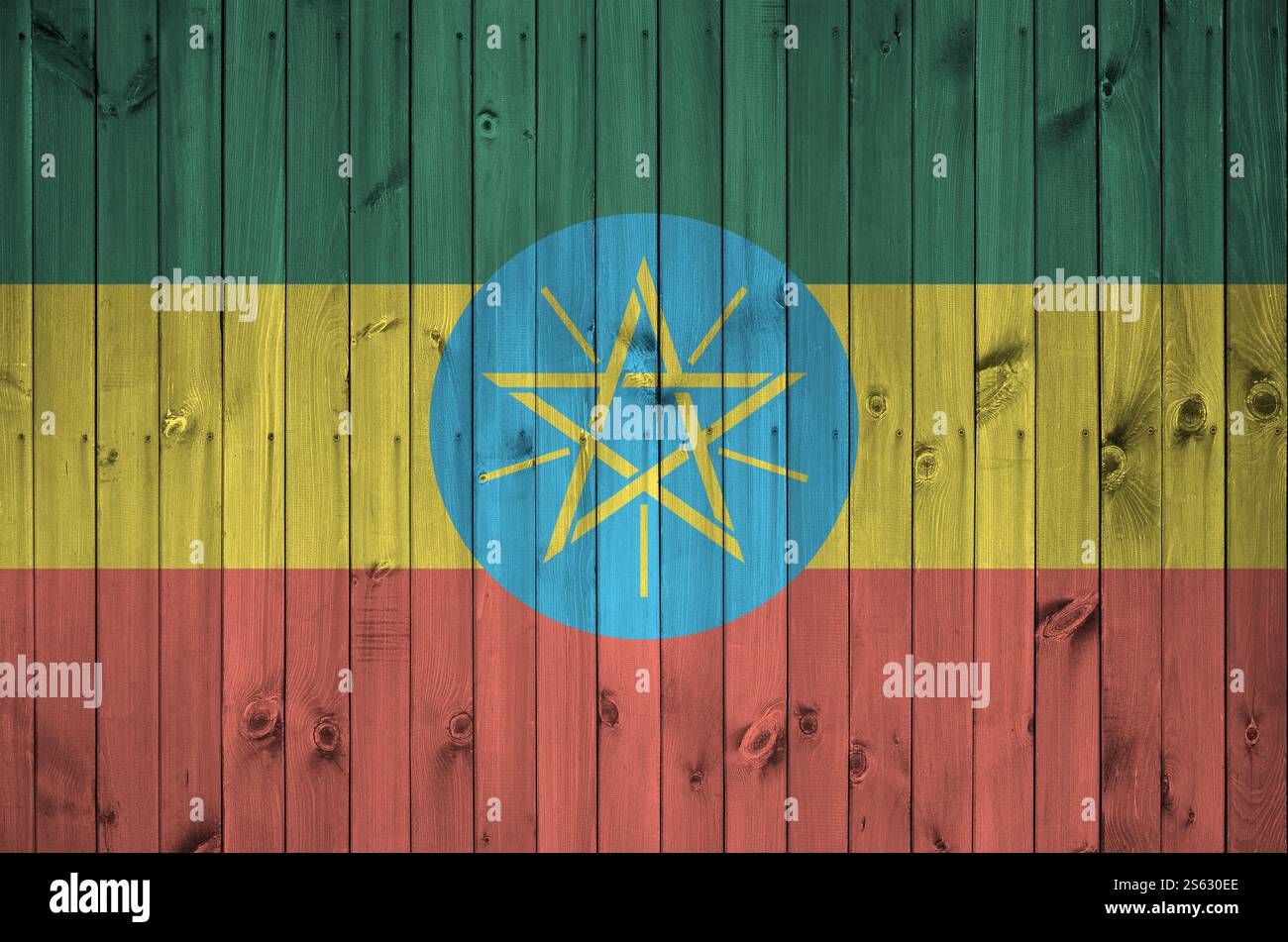 Ethiopia flag depicted in bright paint colors on old wooden wall close ...