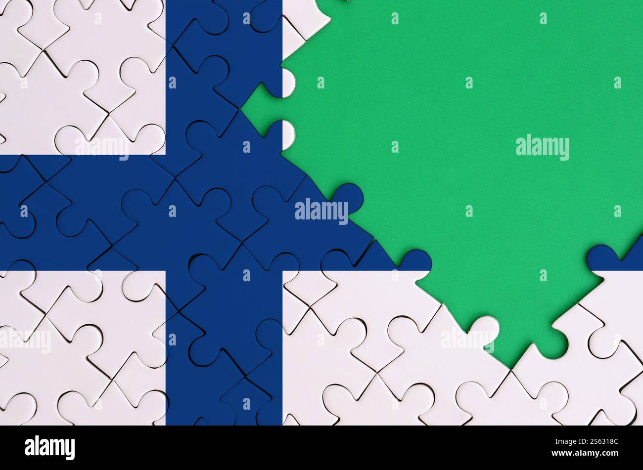Finland flag is depicted on a completed jigsaw puzzle with free green ...