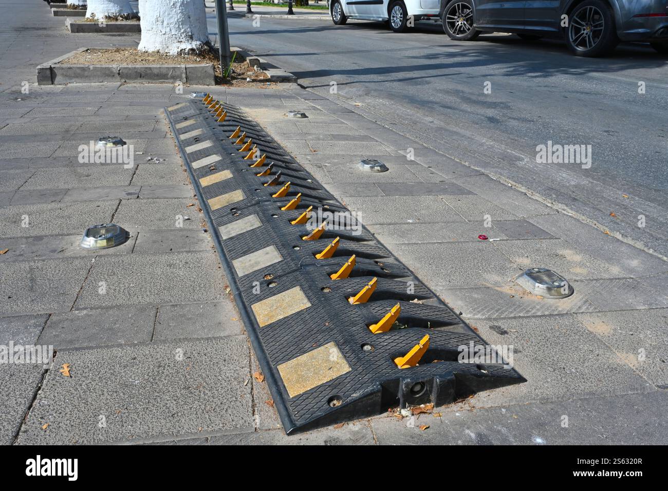 Yellow road barrier with spikes called tyred killer Stock Photo - Alamy