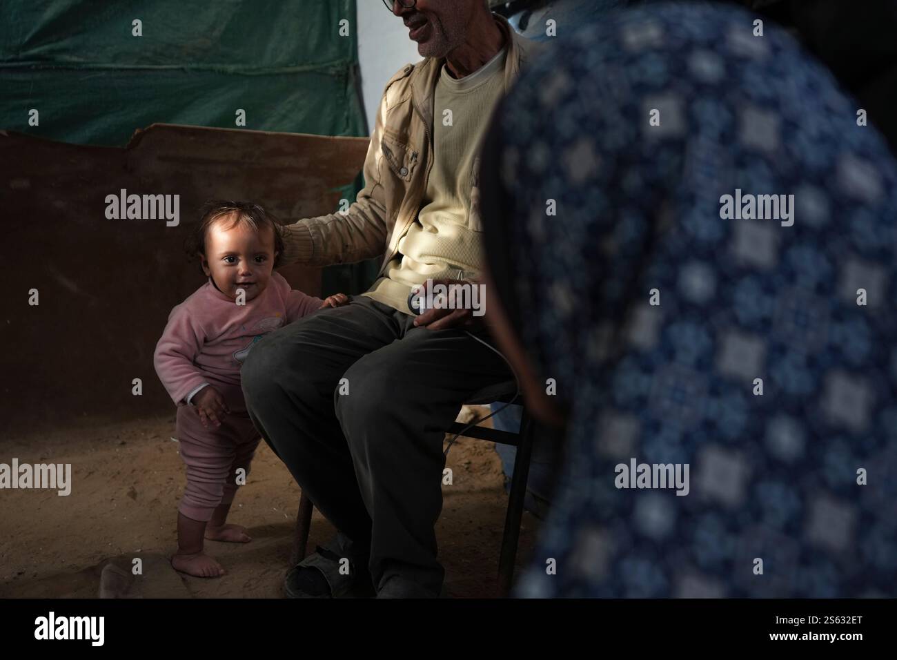 Massa Zaqout, who was born on the first day of the war in Gaza, stands ...