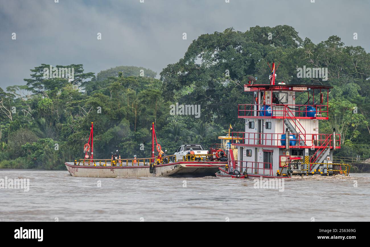 River tugboat pushing barge with vehicle, Napo River, Amazon rainforest ...