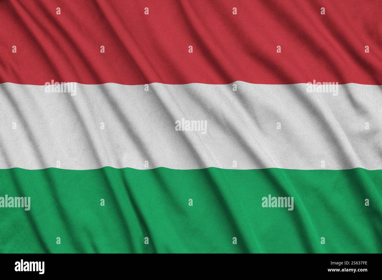 Hungary flag is depicted on a sports cloth fabric with many folds ...