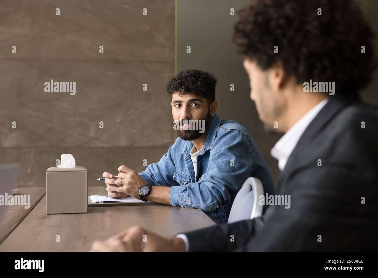 Young office employee talk to teammate during corporate briefing Stock ...