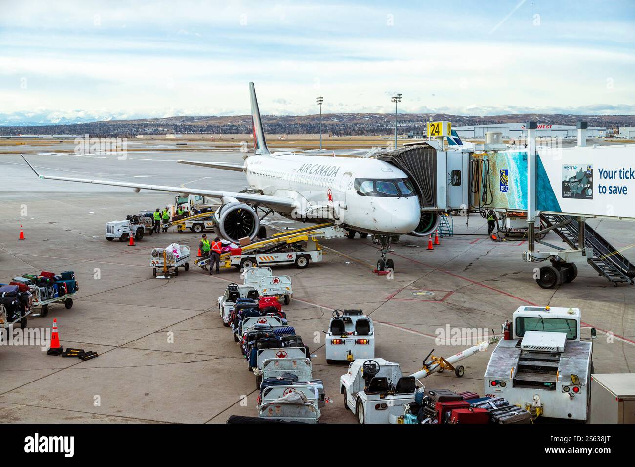 CALGARY, CANADA - DEC. 24, 2024: Ground and baggage handlers loading an ...