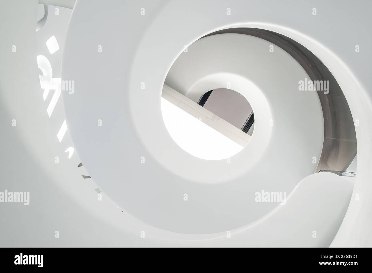 Abstract view of white spiral staircase with smooth curves and ...