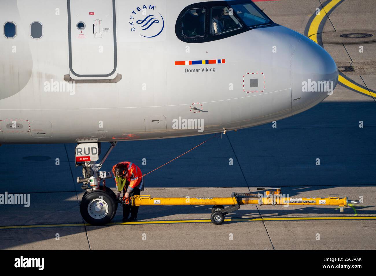Aircraft being towed away from the gate at the terminal, ground crew ...