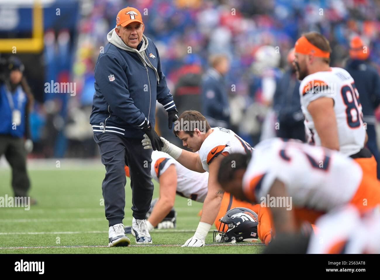 Denver Broncos head coach Sean Payton, left, greets tight end Nate ...