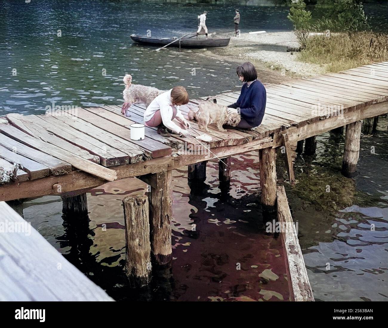 Children playing fishing on jetty Britain 1960 Stock Photo - Alamy