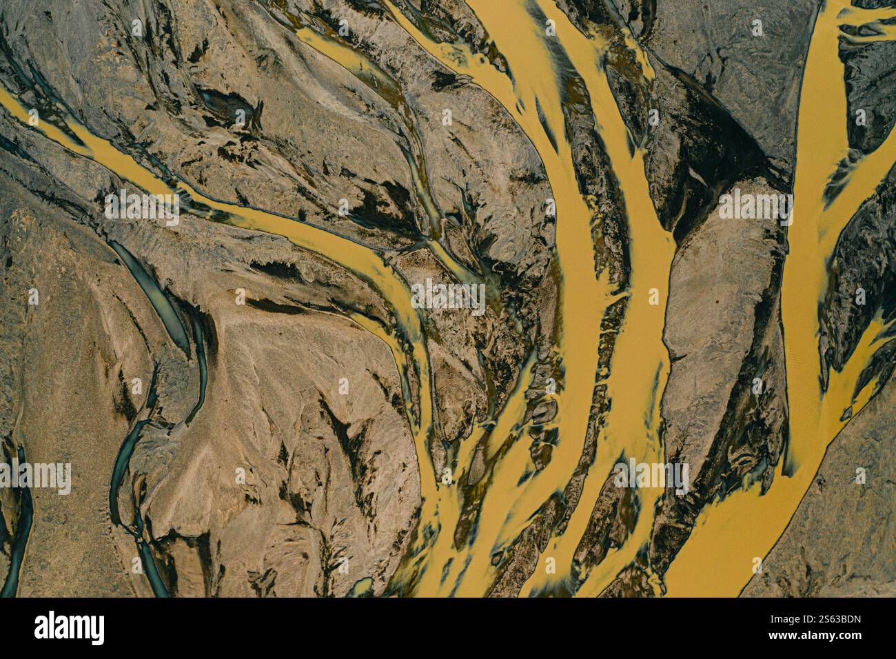 Aerial view of vibrant braided glacial rivers winding through ...