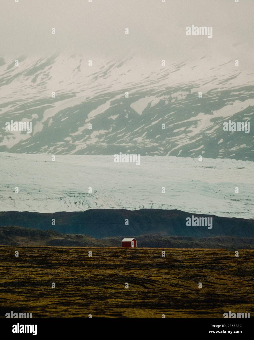 Red cabin against glacier backdrop in Hornafjordur, south Iceland Stock ...