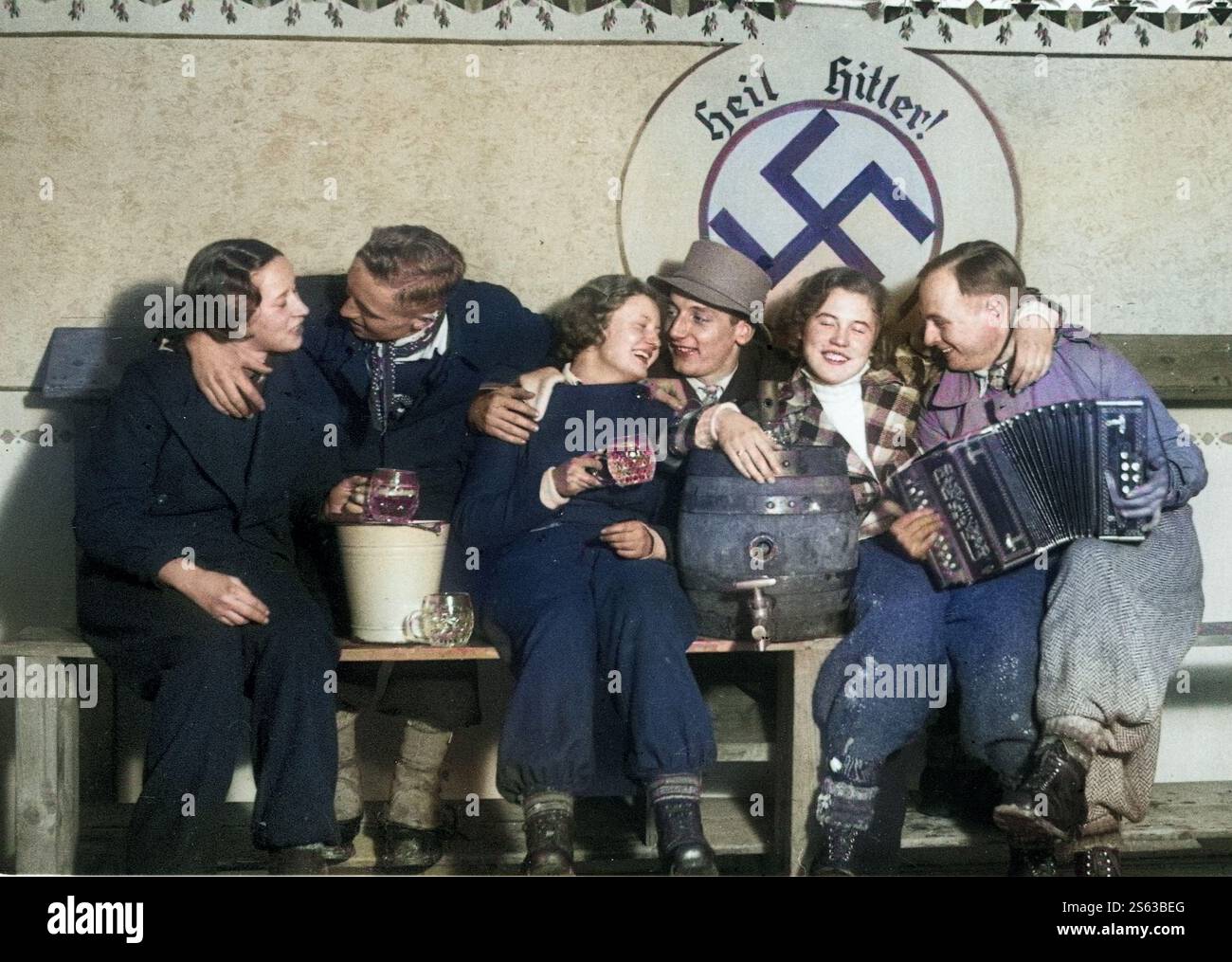 Group of young Germans drinking beer under a Heil Hitler Swastika in ...